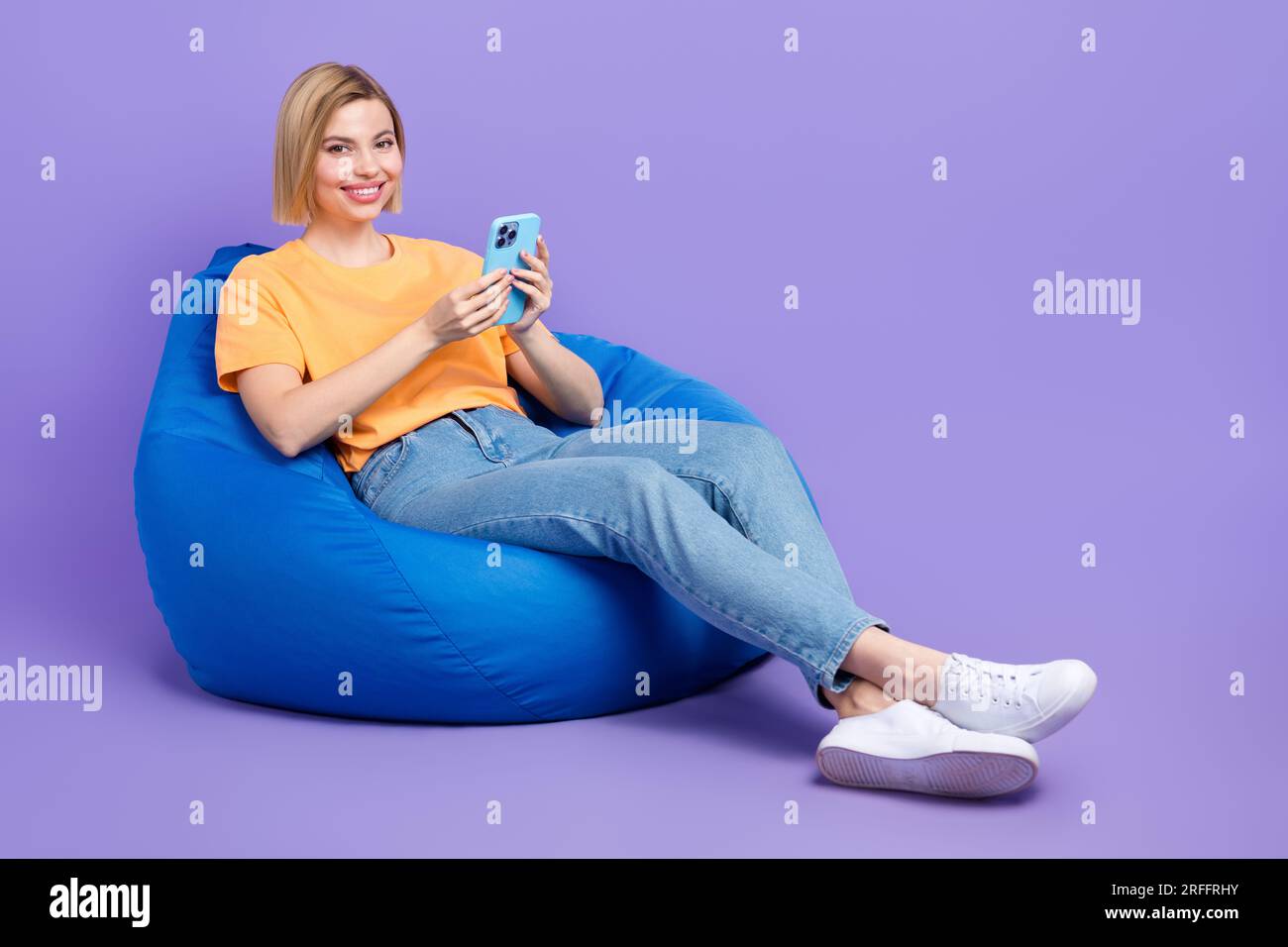 Full body photo of young girl browsing smartphone relaxed chilling bean ...
