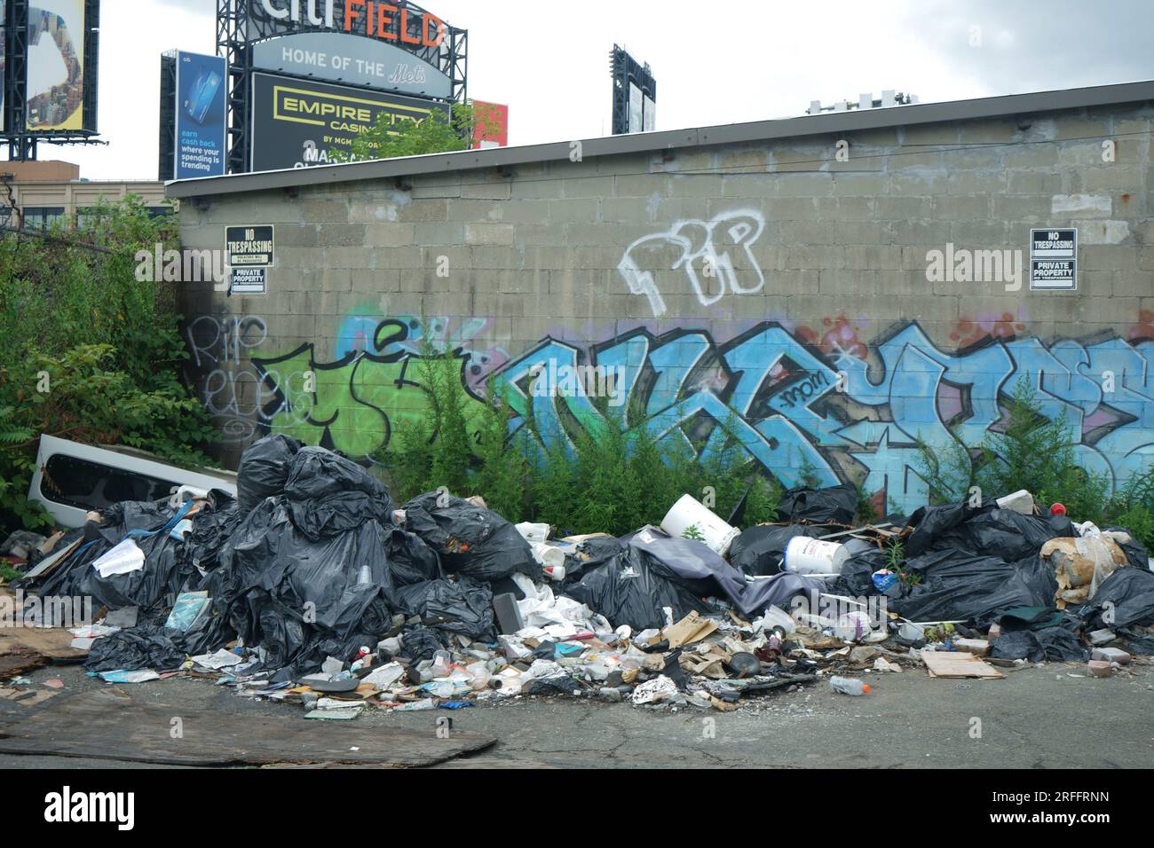 abandonded wall strewn with garbage in willets point, behind citi field ...