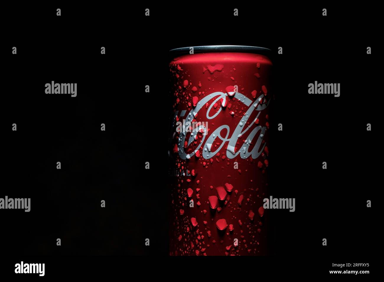 The Coca Cola drink with water drops on a black background, details ...