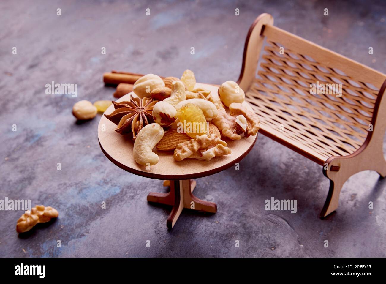 Decorative serving of mixed nuts on small furniture. Healthy desserts ...