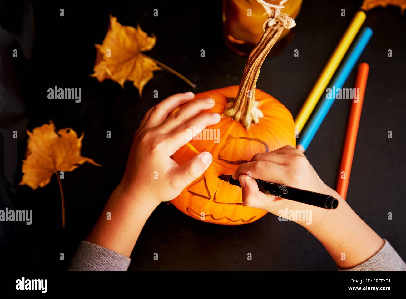 Child drawing a pumpkin of Jack o lantern for Halloween. Handmade ...