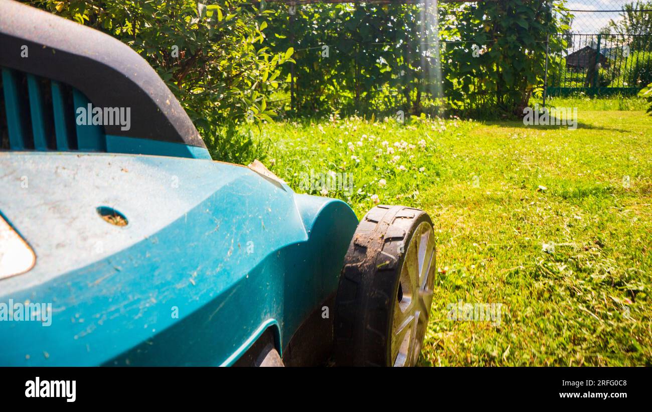 Lawn mover on green grass in modern garden or backyard. Machine for ...
