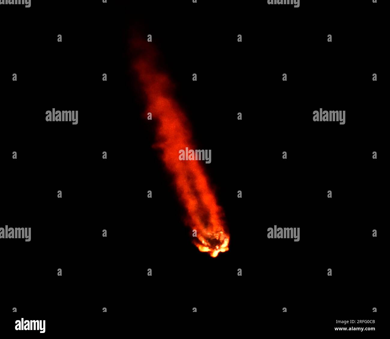 The exhaust plume of the SpaceX Falcon 9 rocket turns red as it ...