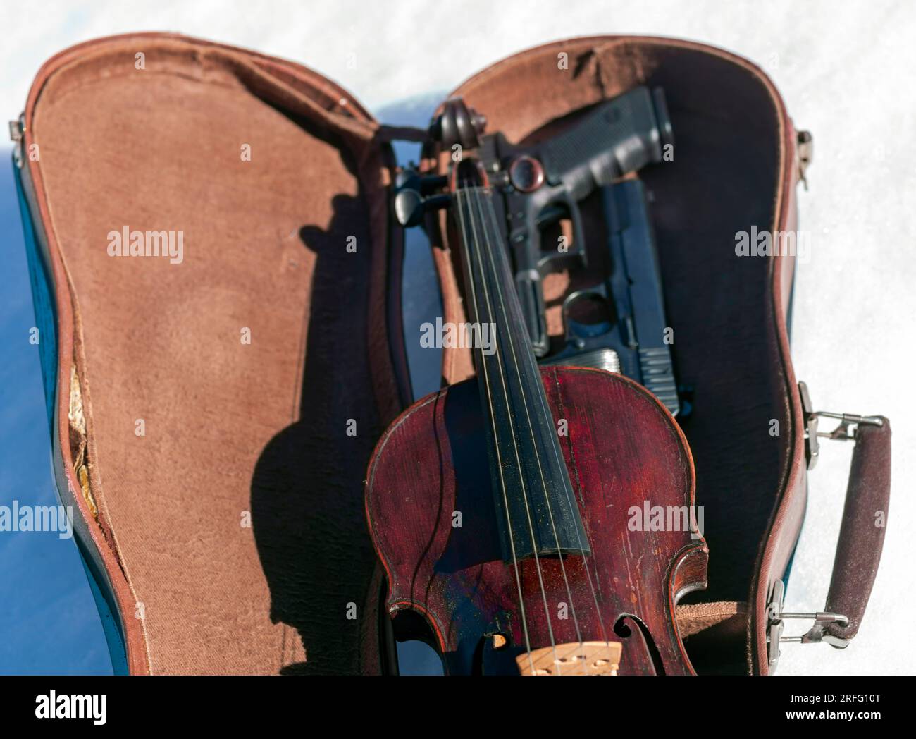 open case with a violin and two pistols hidden inside, outdoor concept ...
