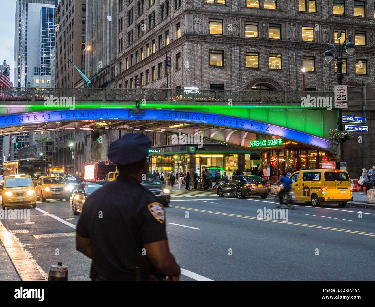 An NYPD Officer looks towards the bridge at Pershing Square, New York ...