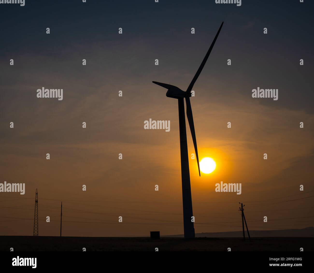 Windmill at sunset. Alternative energy source Stock Photo - Alamy