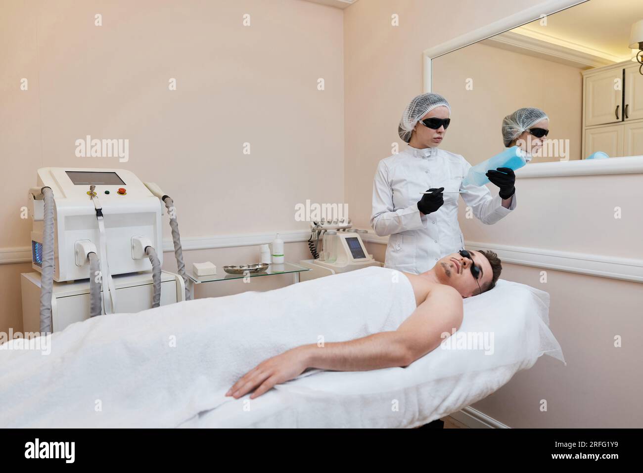 Young man receiving epilation in beauty center. laser hair removal ...