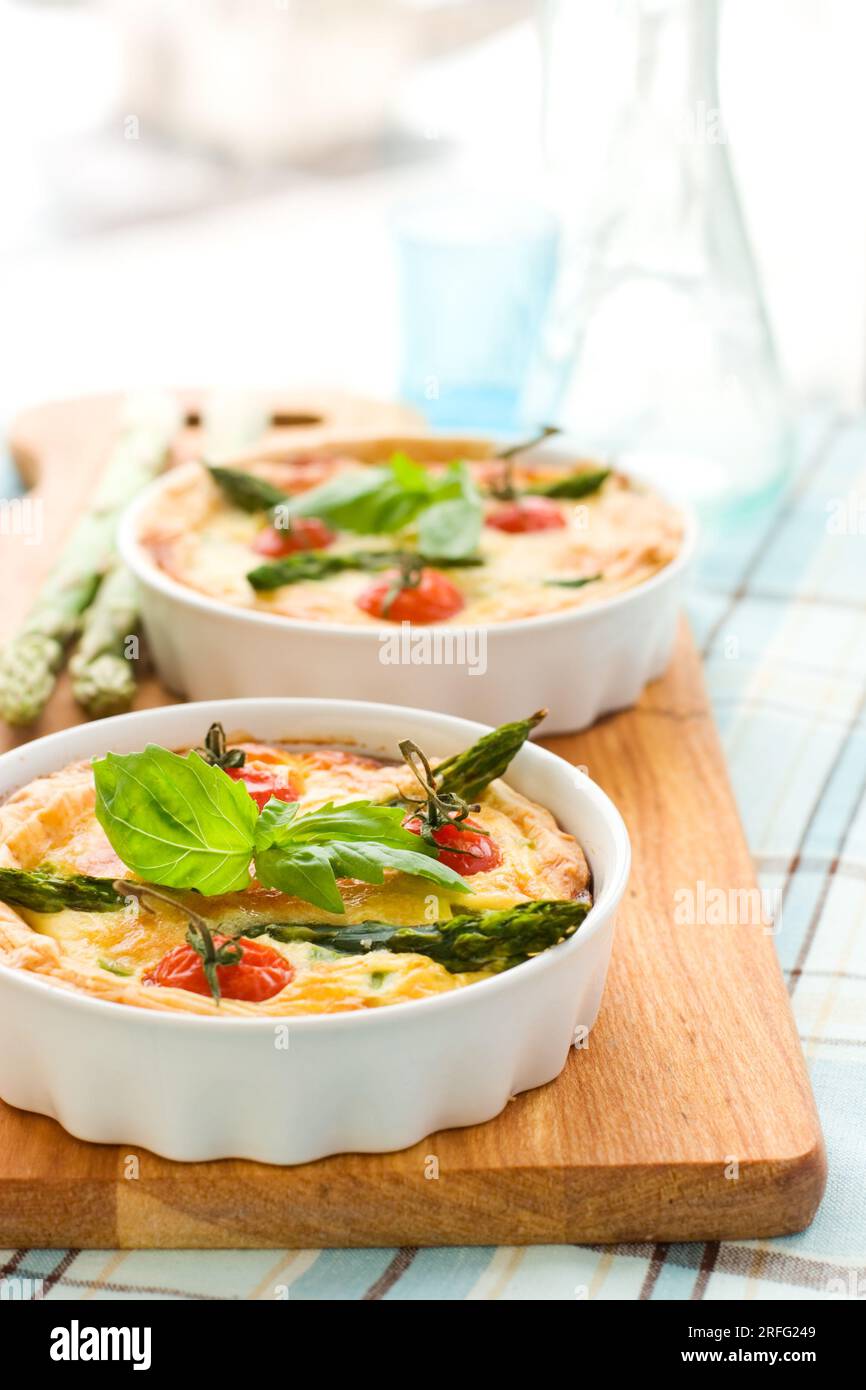 mini quiche witn tomato cherry and green asparagus Stock Photo - Alamy