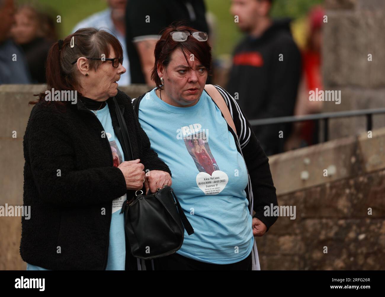 People wear t-shirts with a message and an image of Kiea McCann outside ...