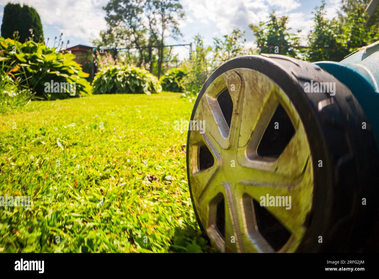 Lawn mover on green grass in modern garden or backyard. Machine for ...