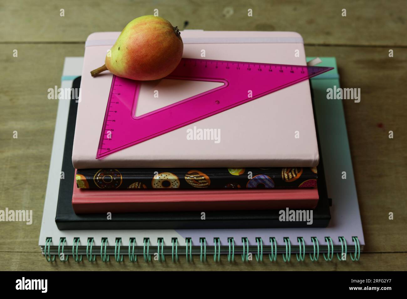 a back to school still life with books, ruller and a pear Stock Photo ...