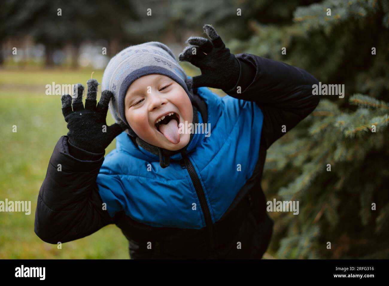 cute little boy putting his tongue out teasing making funny face Stock ...