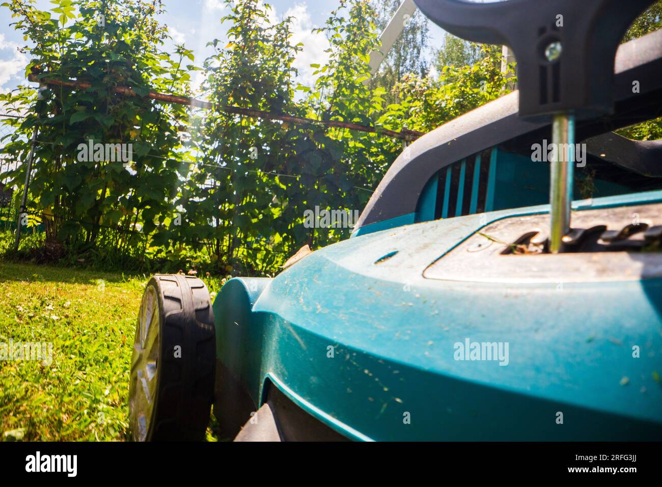 Lawn mover on green grass in modern garden or backyard. Machine for ...