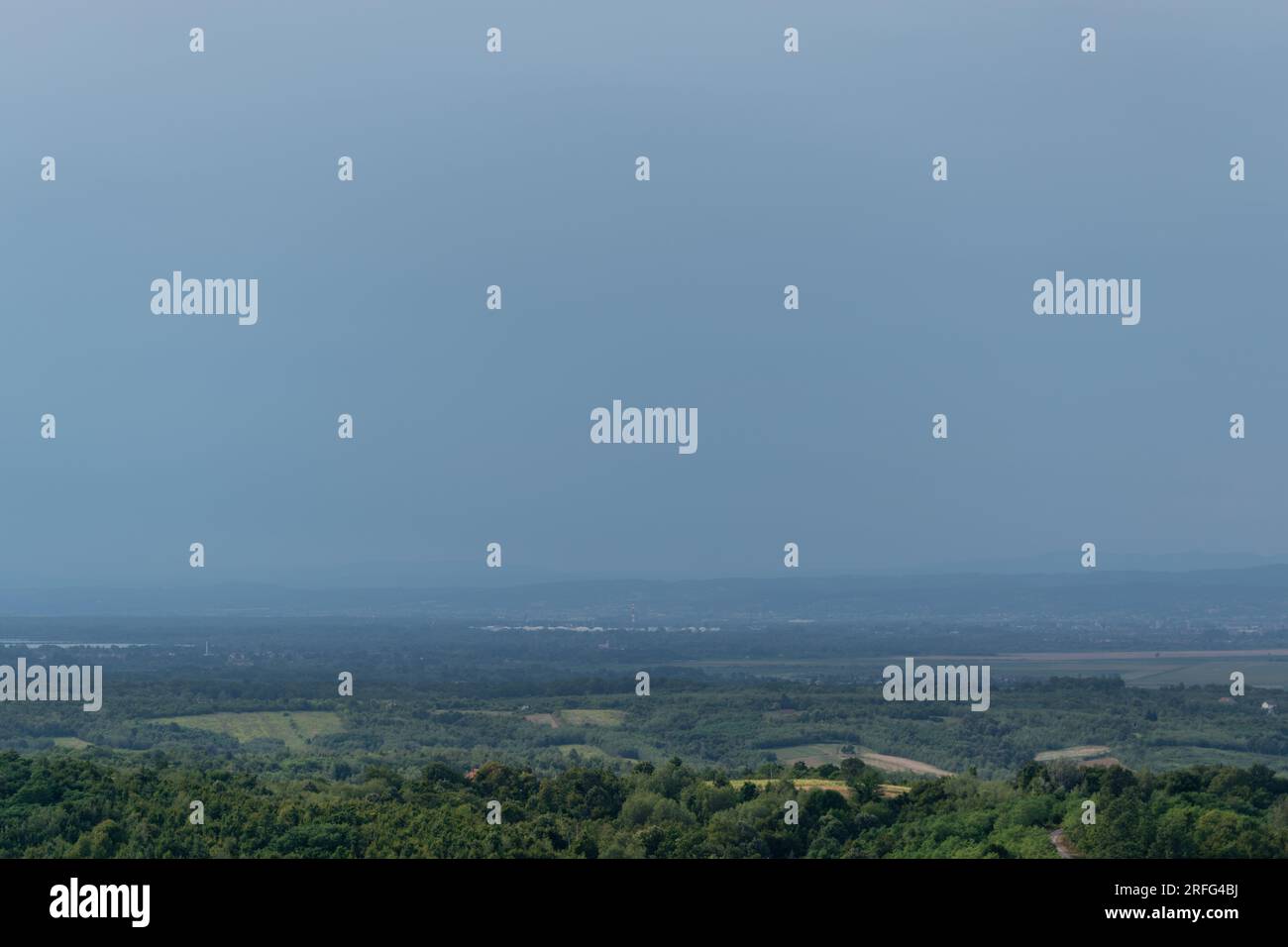 Rural landscape with dense rainfall during summer day, extreme weather ...