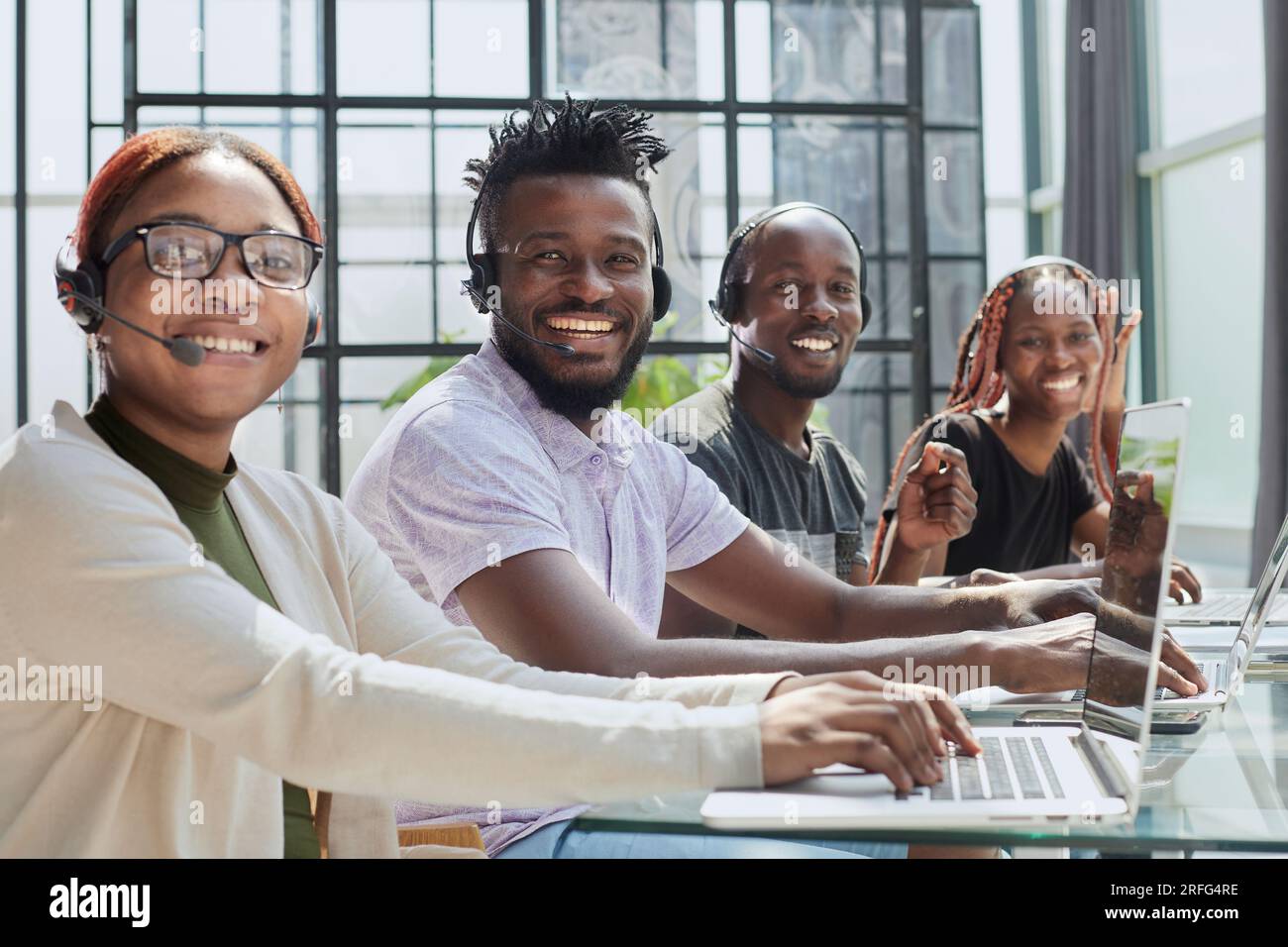 young operators sitting at the workplace posing for the camera Stock ...