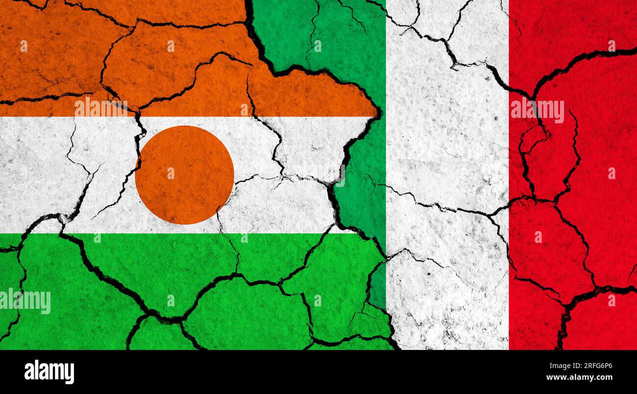 Flags of Niger and Italy on cracked surface - politics, relationship ...