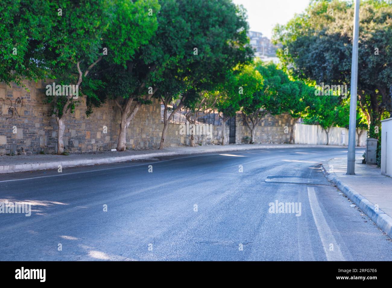 Rural empty asphalt road with sharp turn, asphalt road in the city with ...