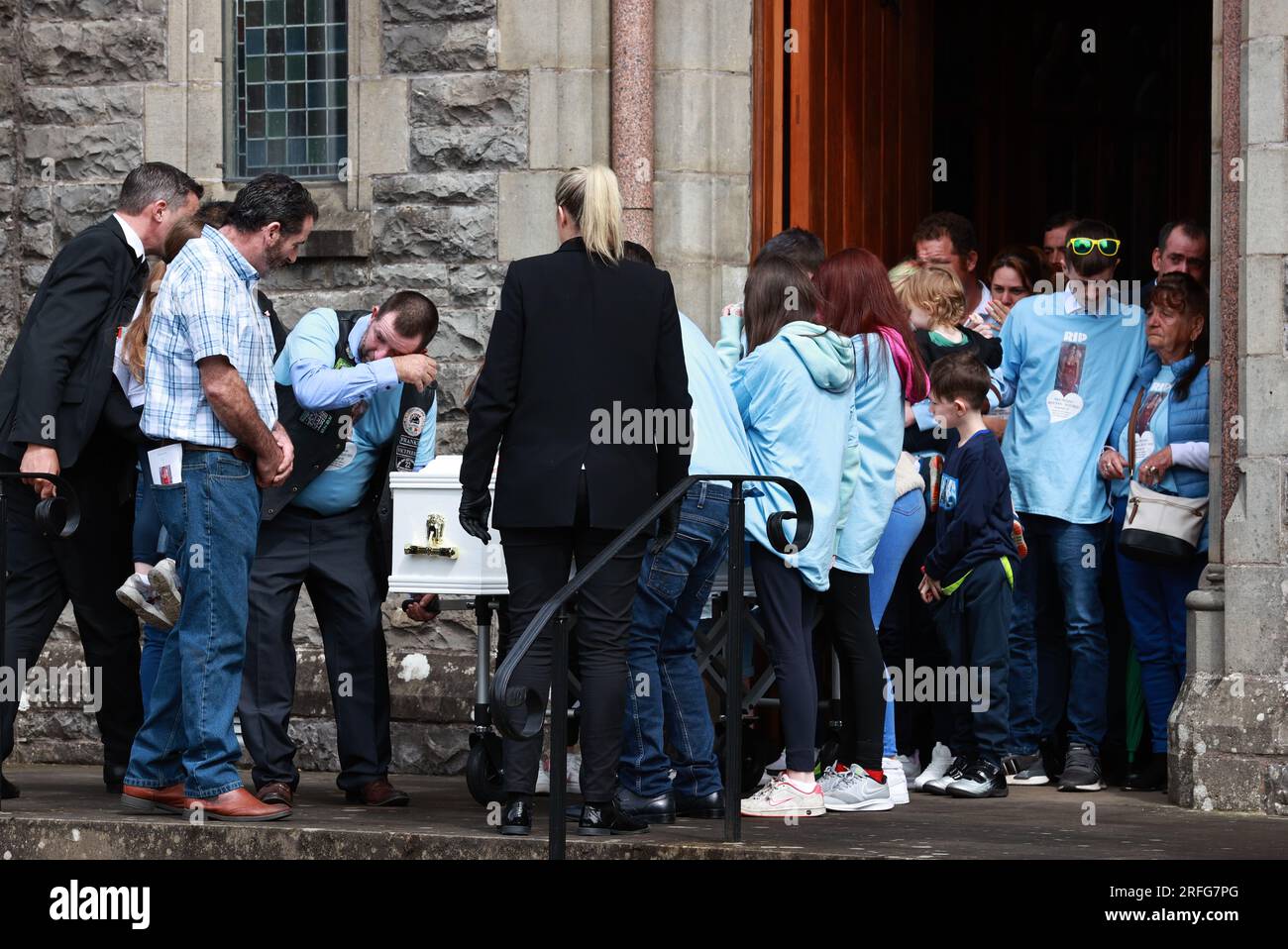 Frankie McCann (3rd left), the father of Kiea, wipes away his tears as ...