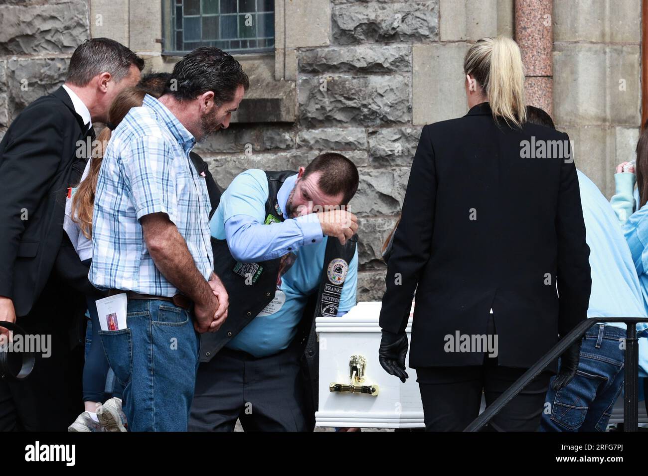 Frankie McCann (centre), the father of Kiea, wipes away his tears as ...