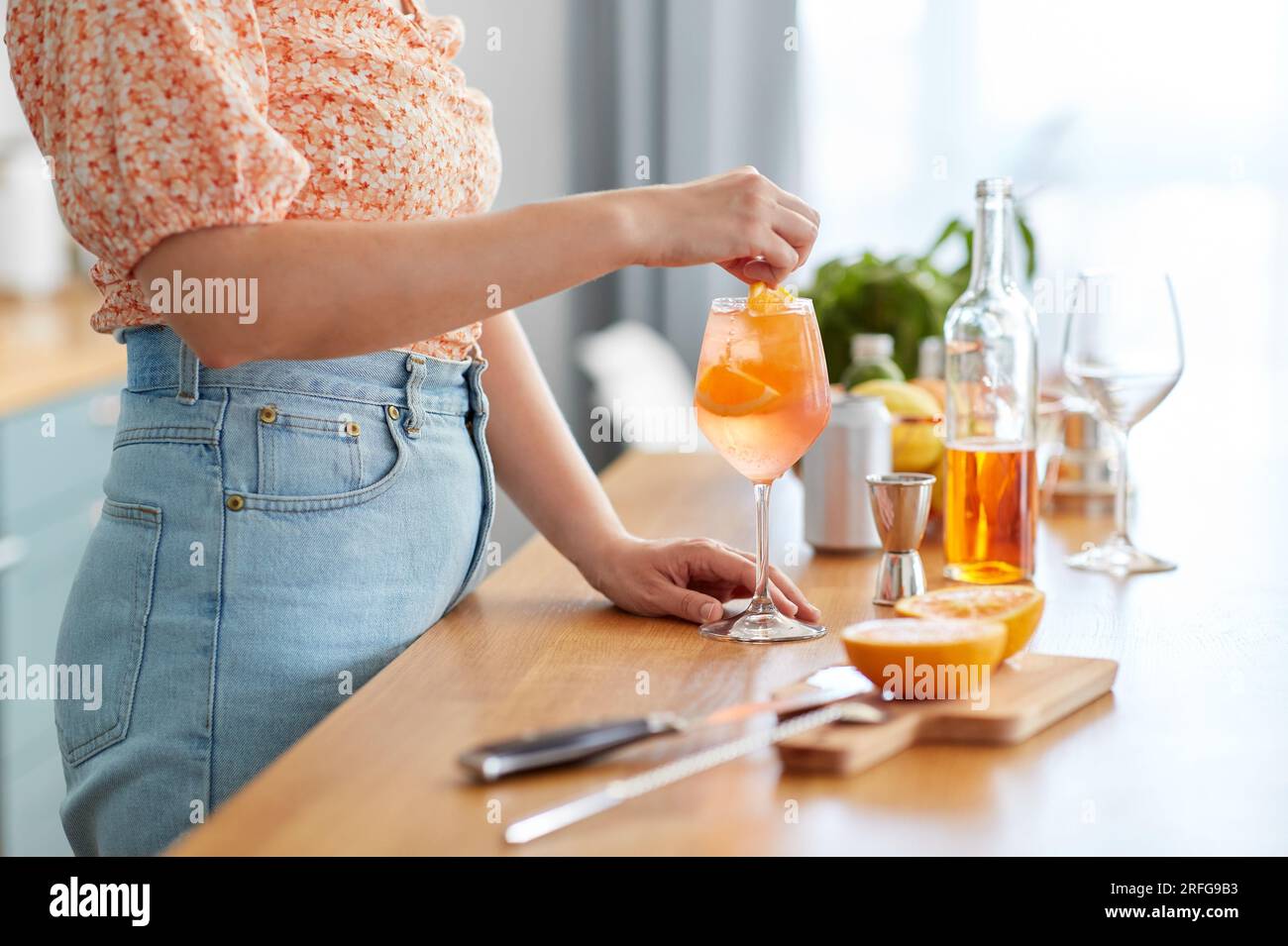 woman making orange cocktail drinks on kitchen Stock Photo - Alamy