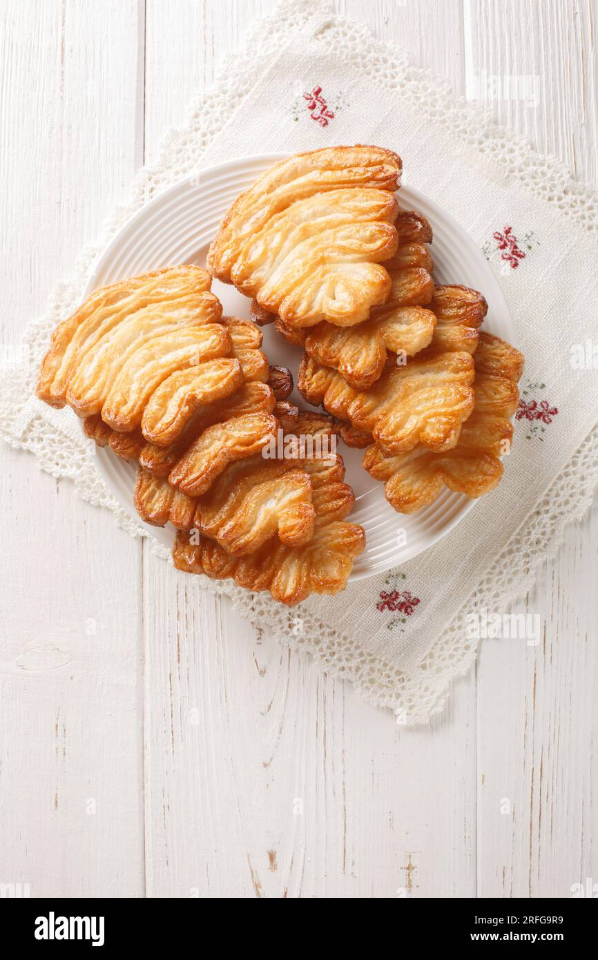 Italian puff pastry Palmine pasta sfoglia closeup on the plate on the ...