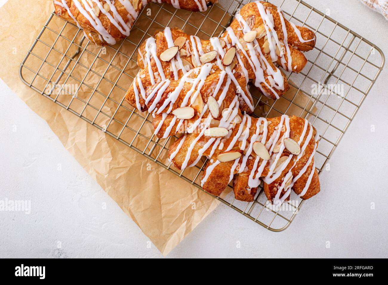 Bear claw pastry on a cooling rack with glaze and sliced almonds Stock ...