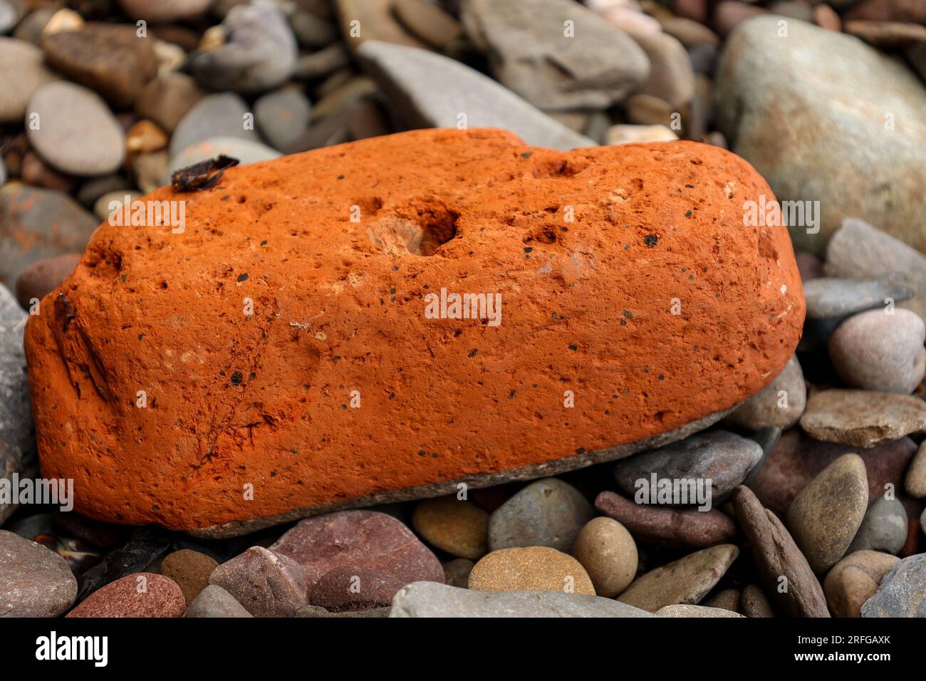 Red stones on the shore of the Atlantic Ocean Stock Photo - Alamy