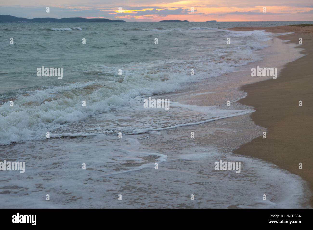 Raging Sea with Sunset Sky Background Stock Photo - Alamy