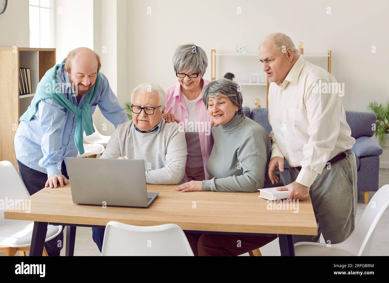 Group of senior people in retirement home using laptop computer and ...