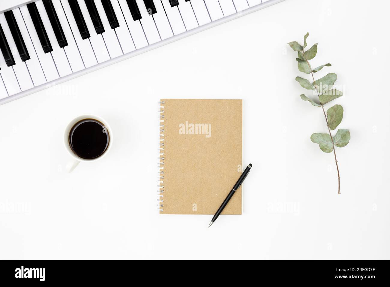 Musical keyboard, notepad and coffee cup on a white background. Flat ...
