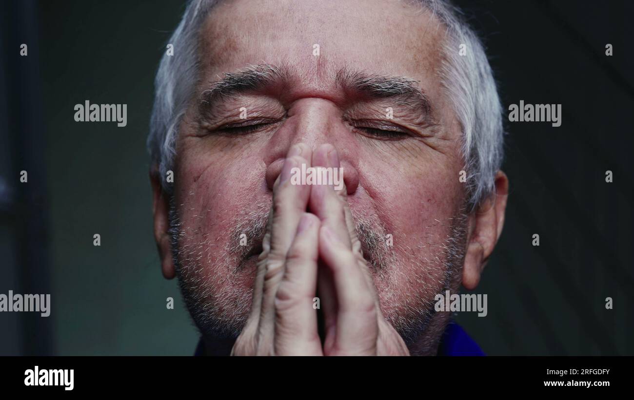 Religious Elderly Man Praying to GOD with eyes closed in Spiritual ...
