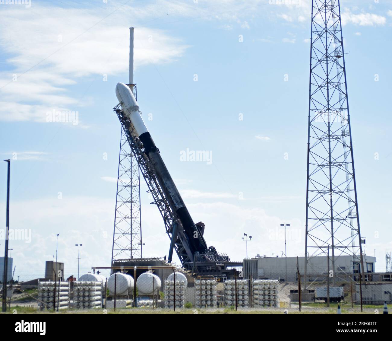 The SpaceX Falcon 9 rocket is raised to a vertical position as it is ...