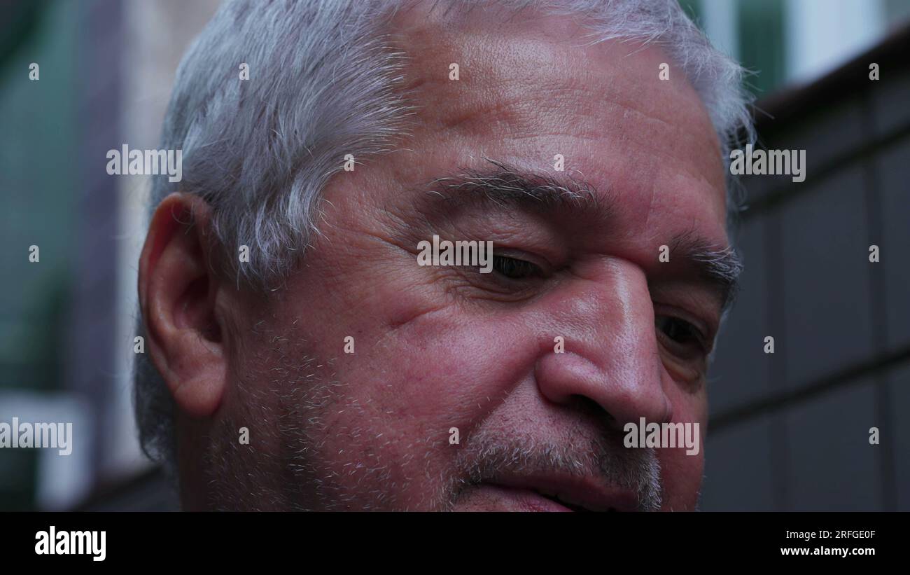 Close-up face of a senior man looking up at sky with HOPE and FAITH ...