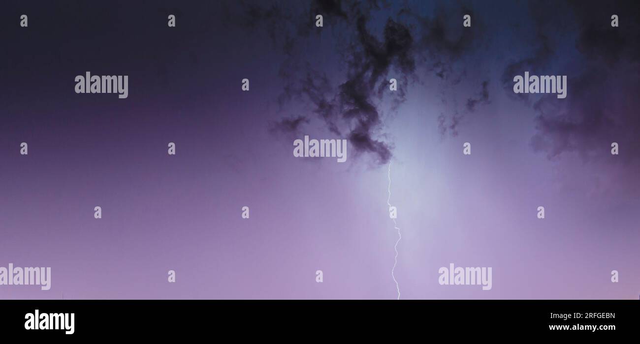 Picture of a flash in the night sky with glowing clouds in summer Stock ...