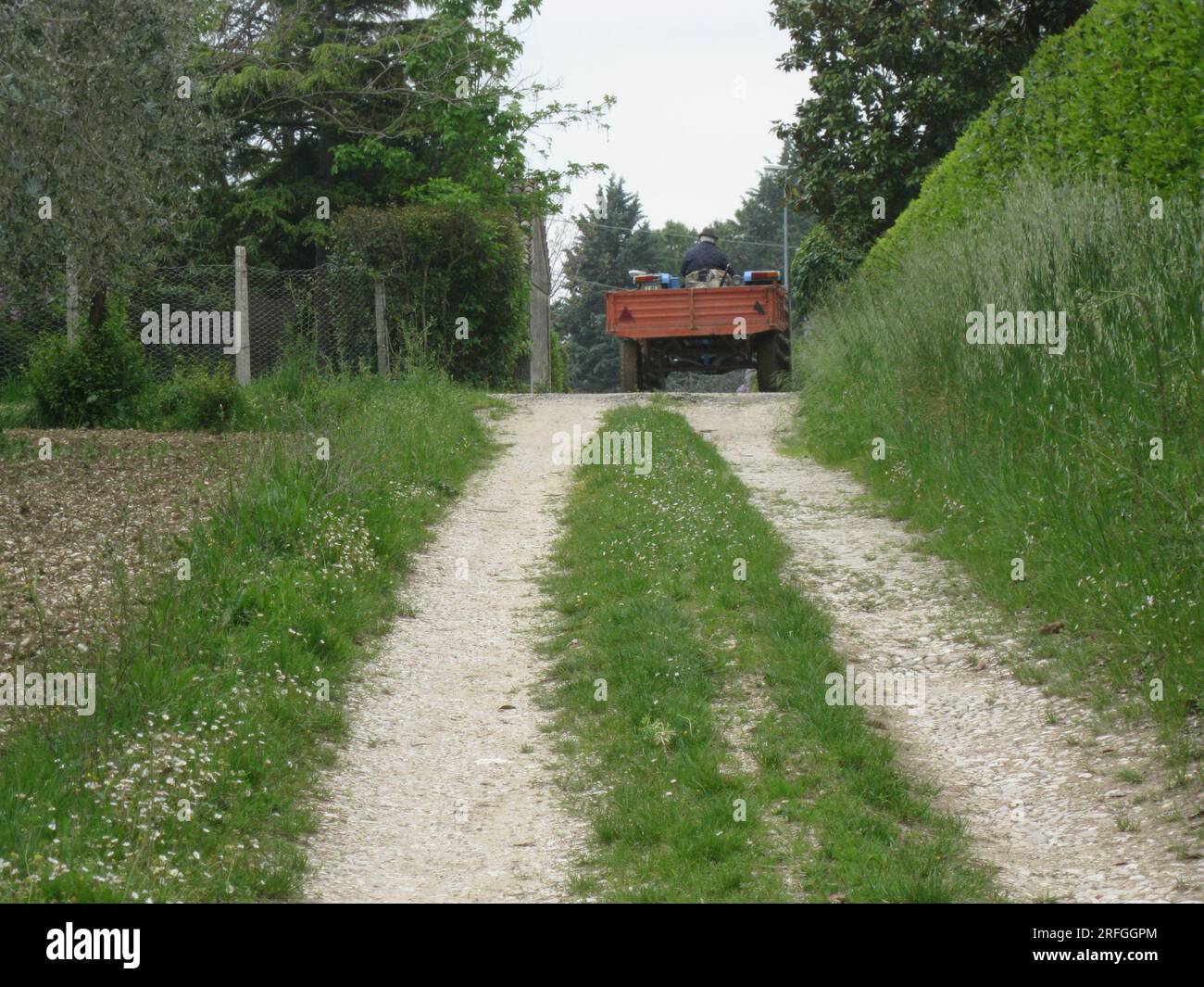 A man driving away his tractor Stock Photo - Alamy