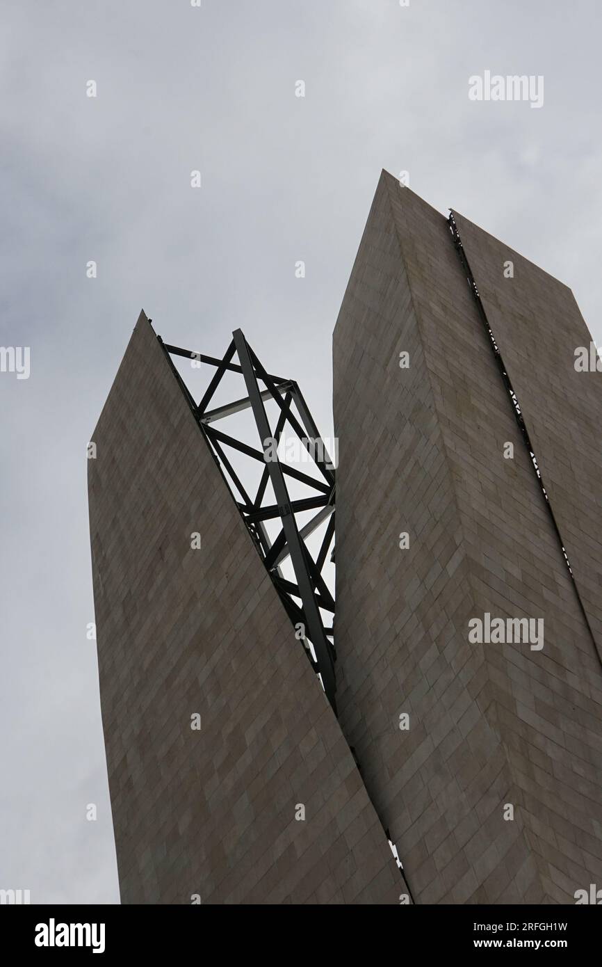Vertical photograph of a metallic structure with cloudy sky Stock Photo ...