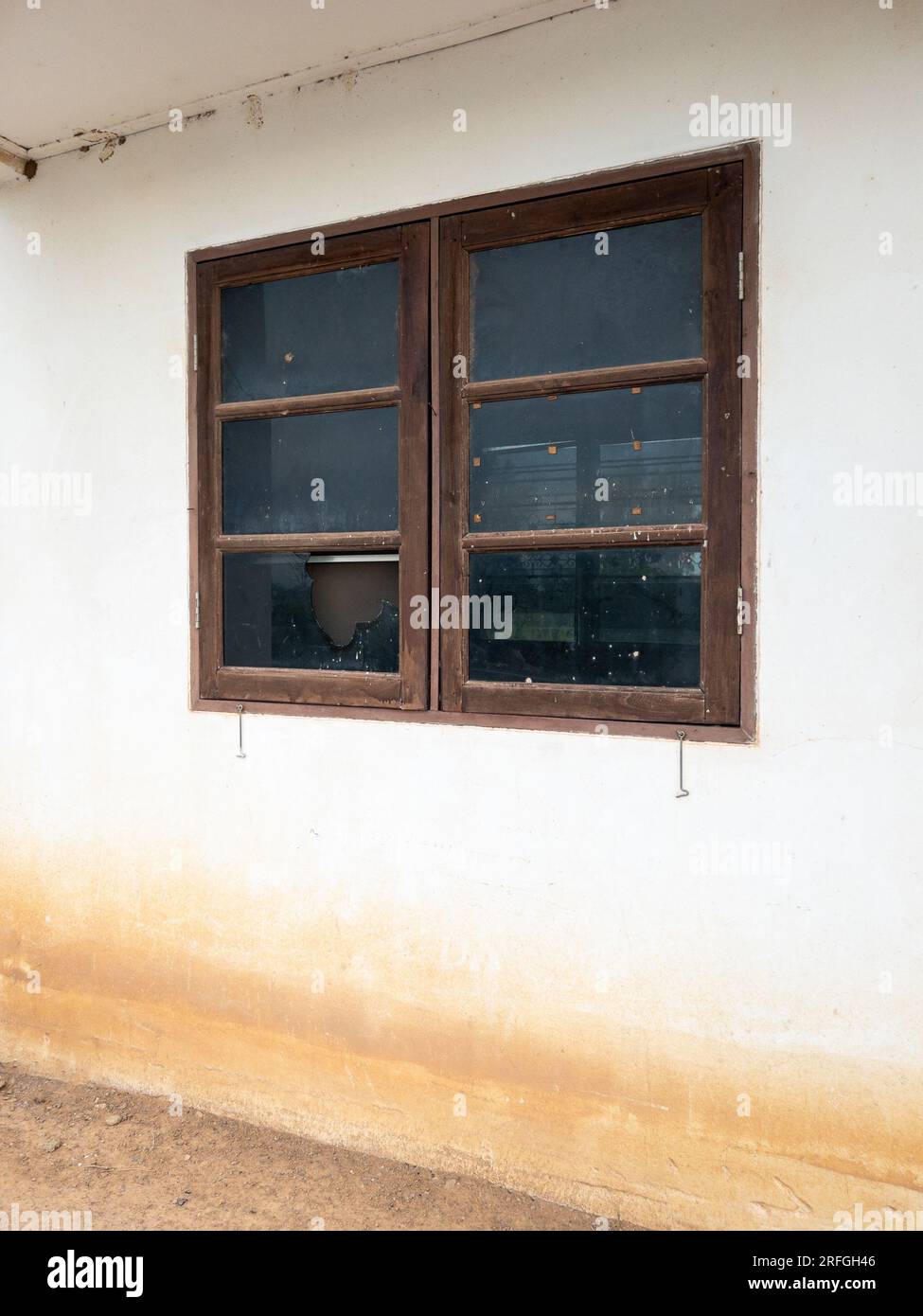 The broken window on the white wall with the water stain after flood ...