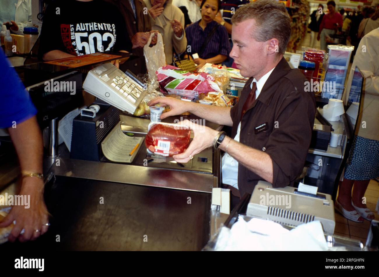 Young Assistant Scanning Bar Code at Checkout In Sainsbury's ...