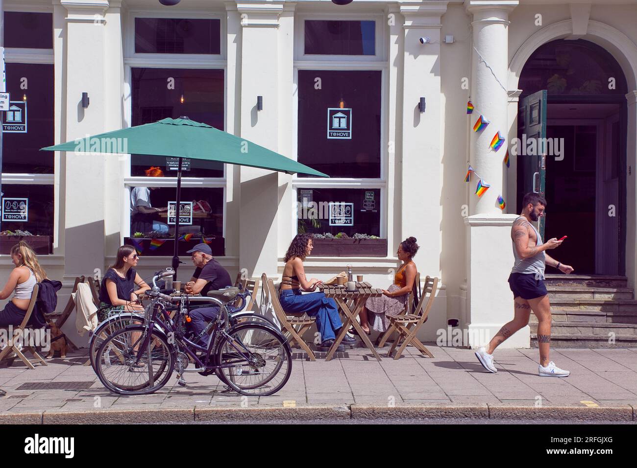 England, East Sussex, Brighton, Hove, Western Road, People sat outside ...
