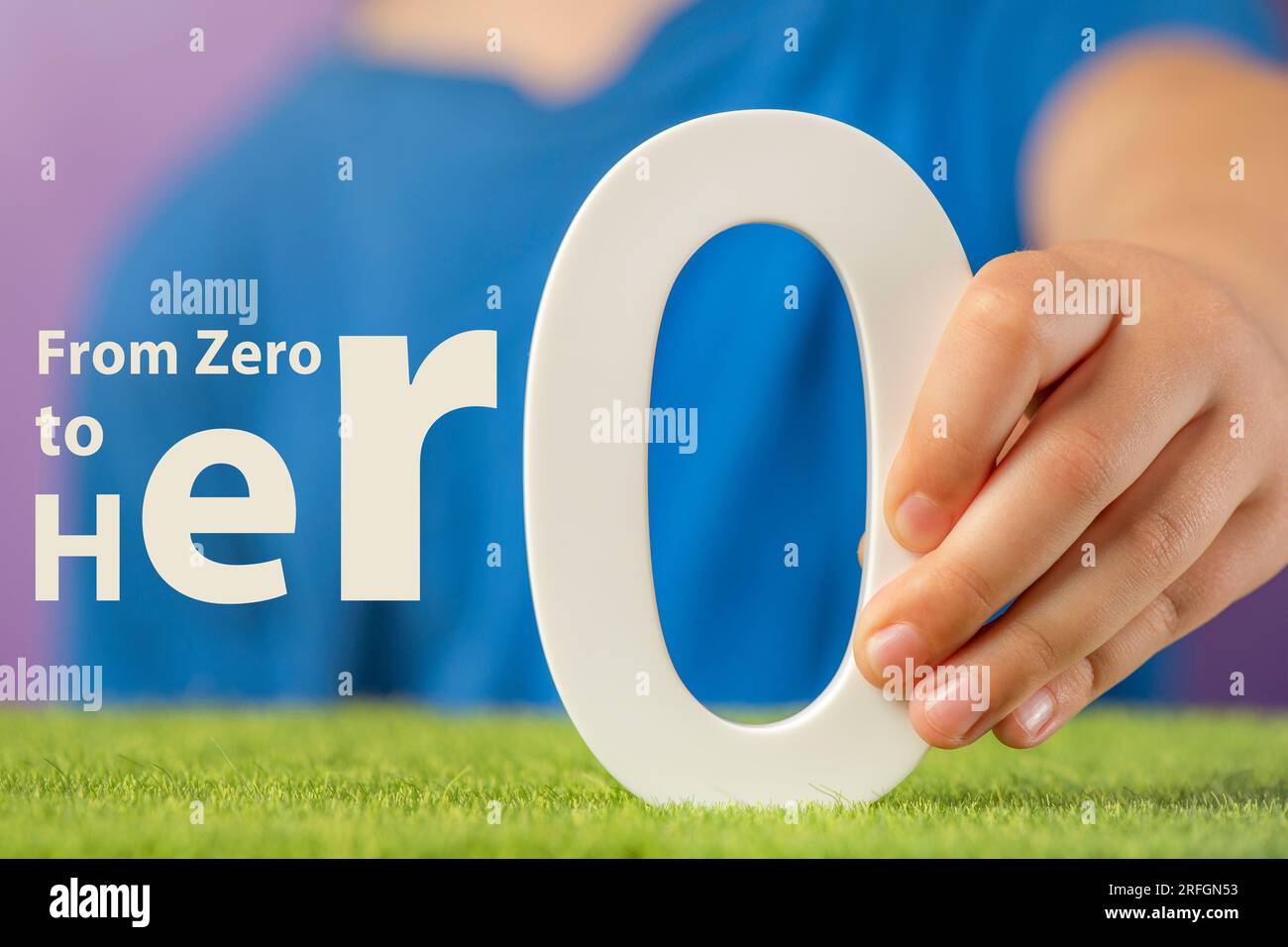 From Zero to Hero. Close-up concept photo of a hand holding a white ...