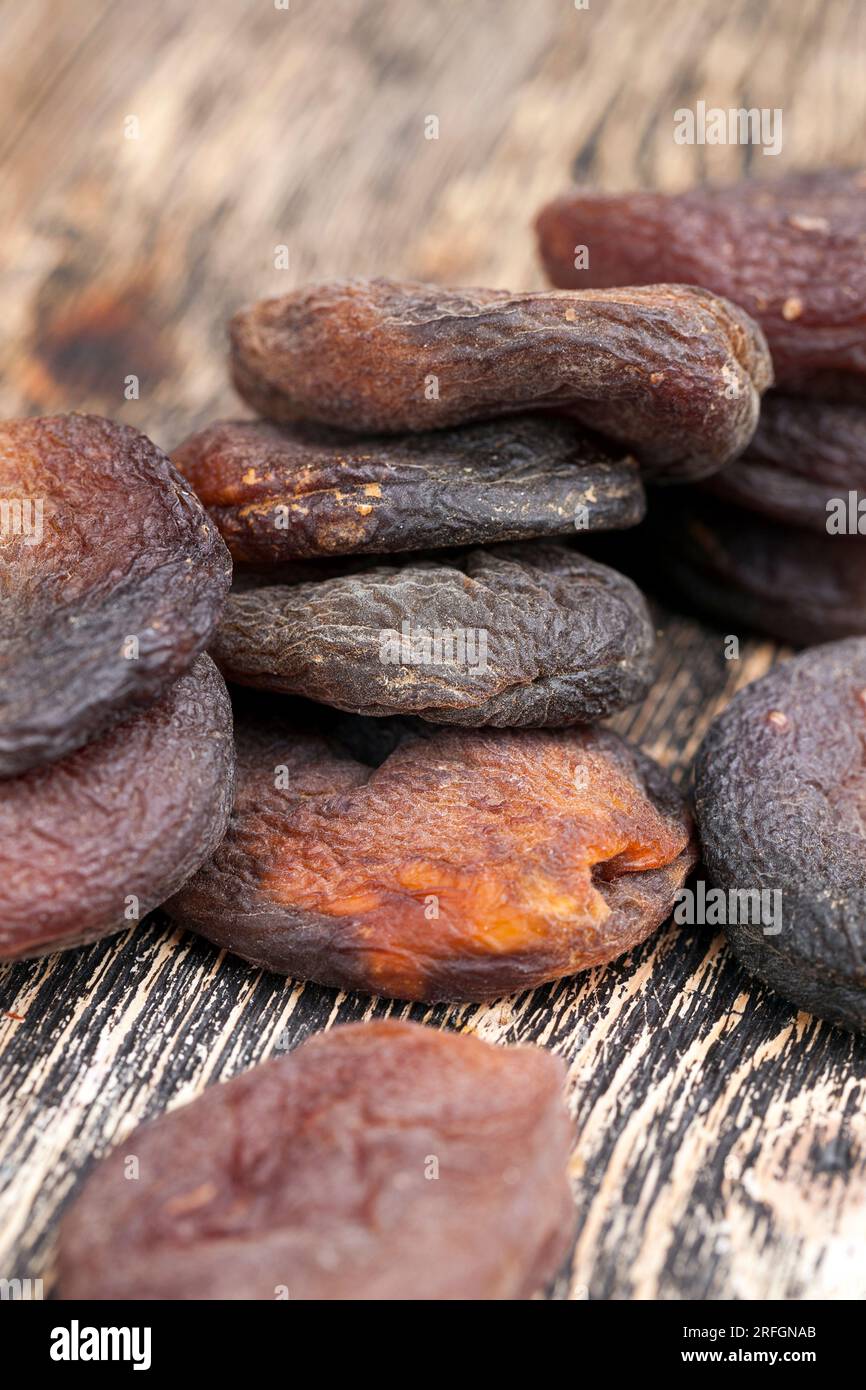 dark dried apricots of large size, dried apricots in sunlight with ...