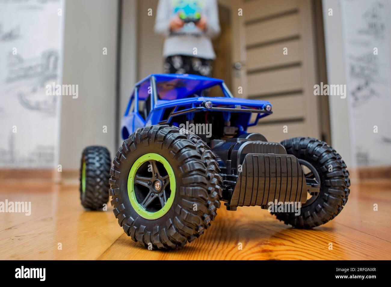 The boy is controling the blue toy car with a remote control Stock ...