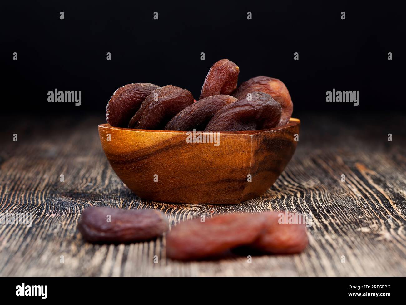 dark dried apricots of large size, dried apricots in sunlight with ...