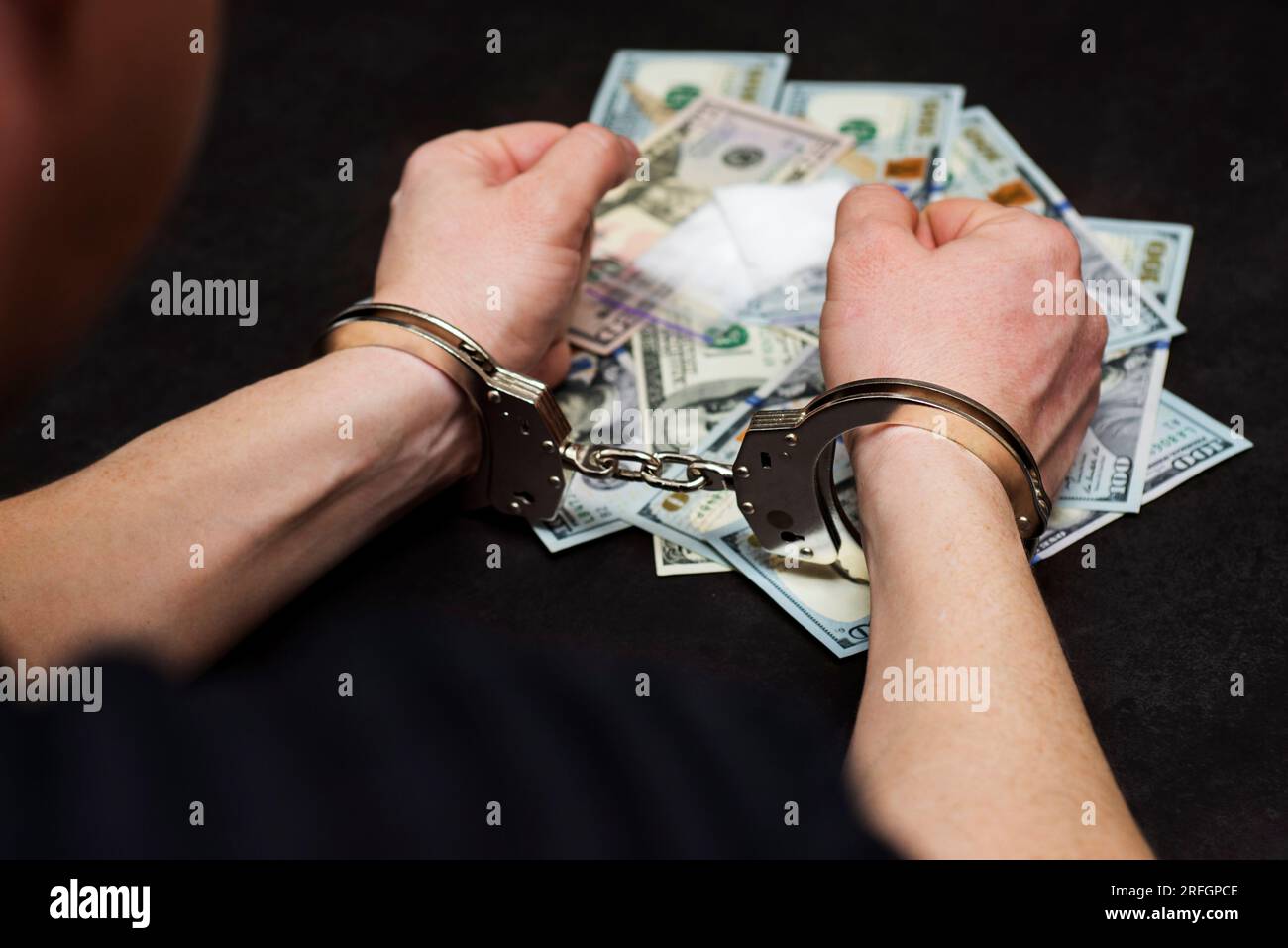Man in handcuffs with money and drugs on dark background Stock Photo ...