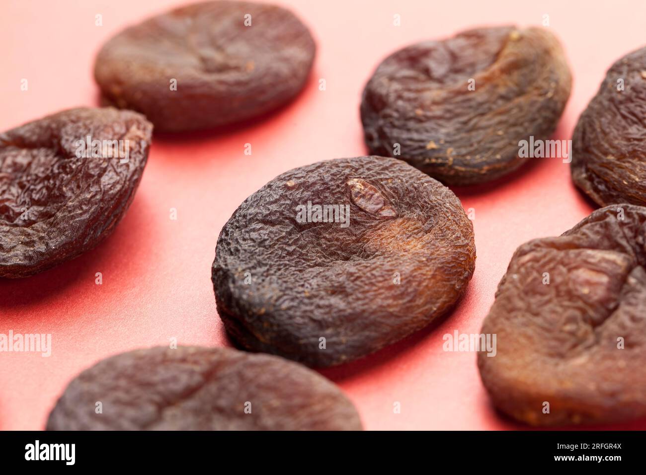 dark dried apricots of large size, dried apricots in sunlight with ...