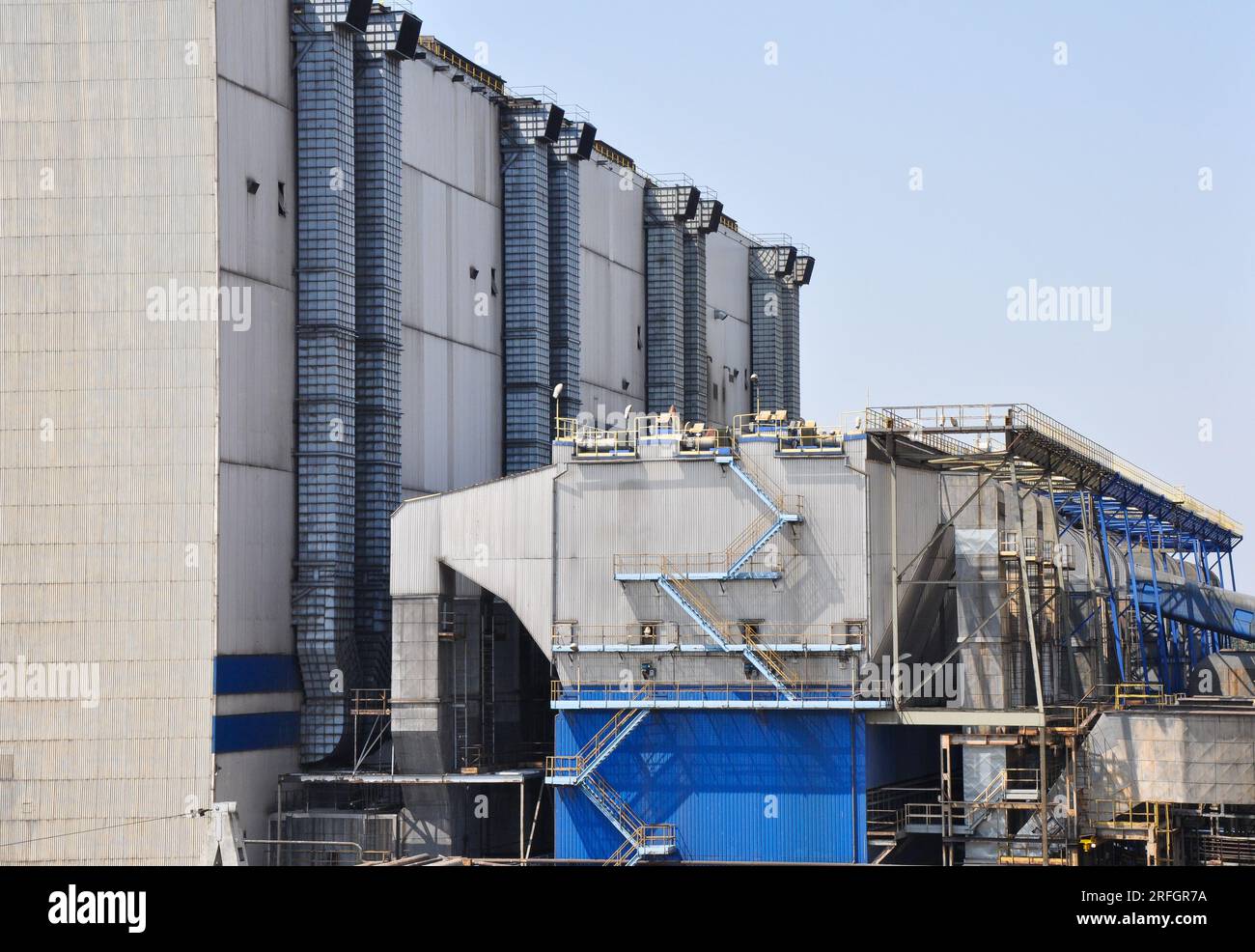 Old and rusty thermal power plant, stack, blue sidewalk, steel ...