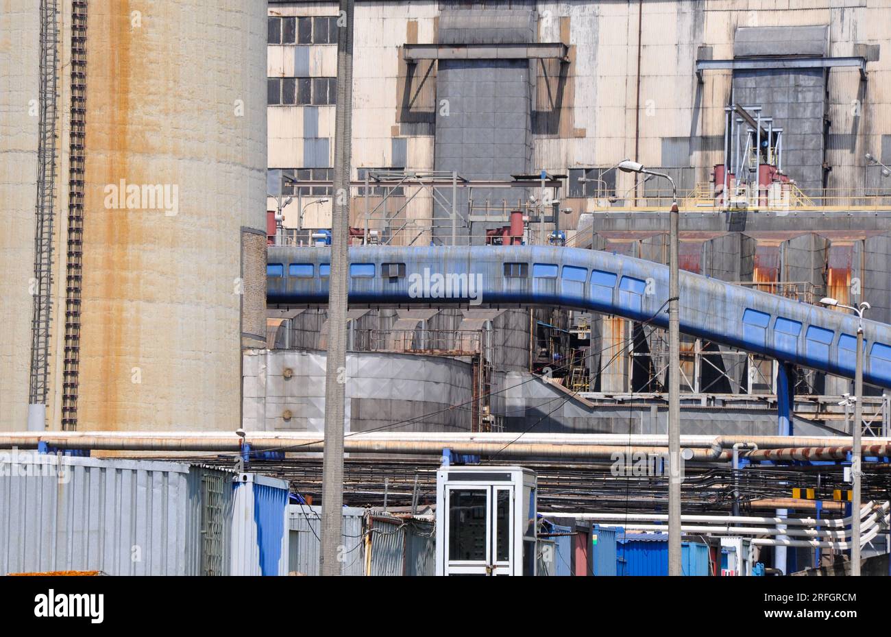 Old and rusty thermal power plant, stack, blue sidewalk, steel ...