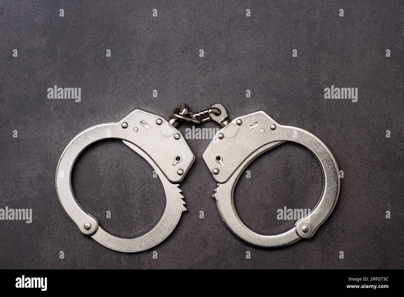 The metal handcuffs on black background. Handcuff or shackle. Police ...