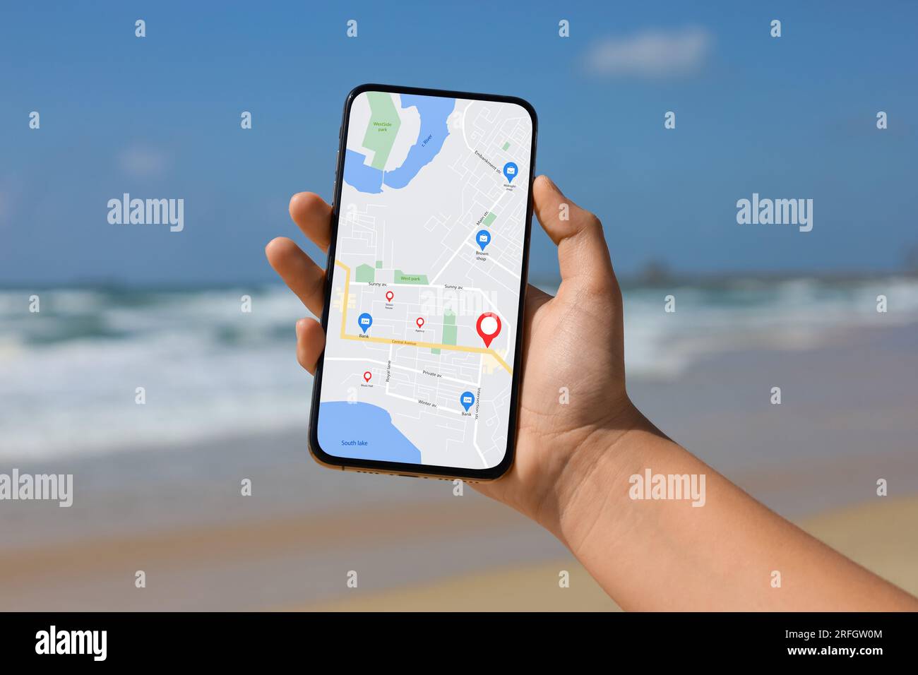 Woman using mobile phone for navigation at sea resort, closeup Stock ...