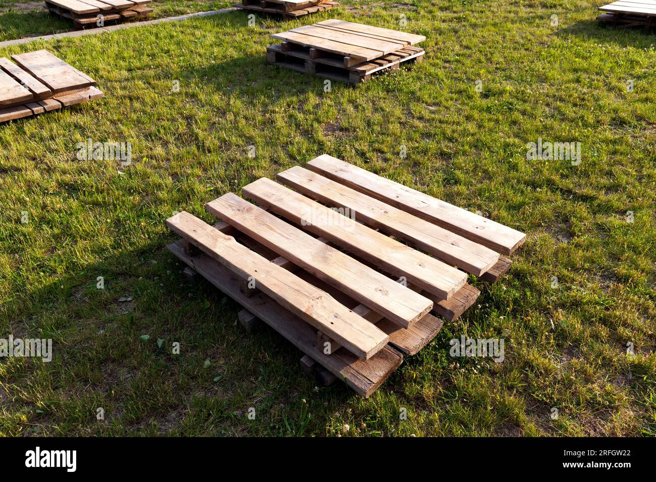 wooden pallets on the grass, which are used as tables or a place to sit ...